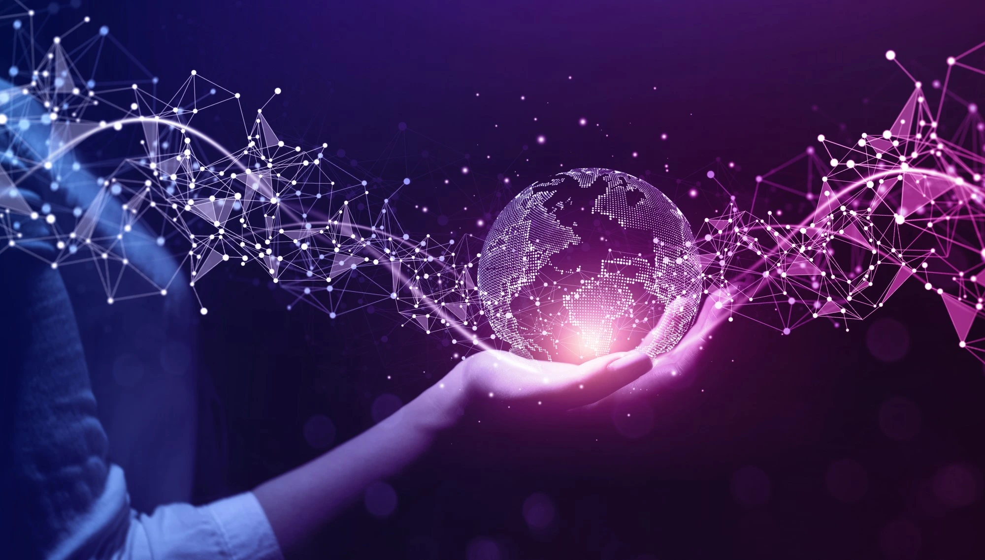 A hand holding a digitalised version of the globe